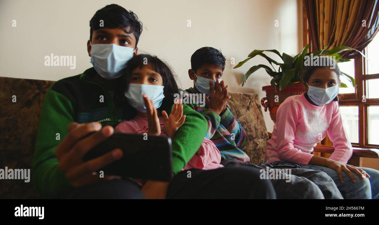 Cute children with masks playing at home Stock Photo - Alamy