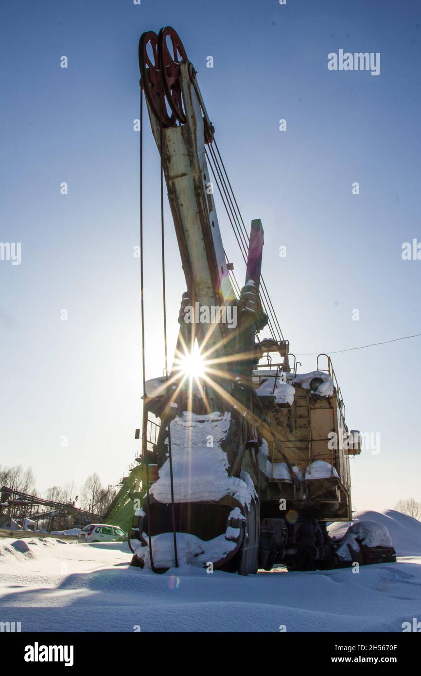 An old quarry excavator abandoned in a snow-covered quarry Stock Photo ...