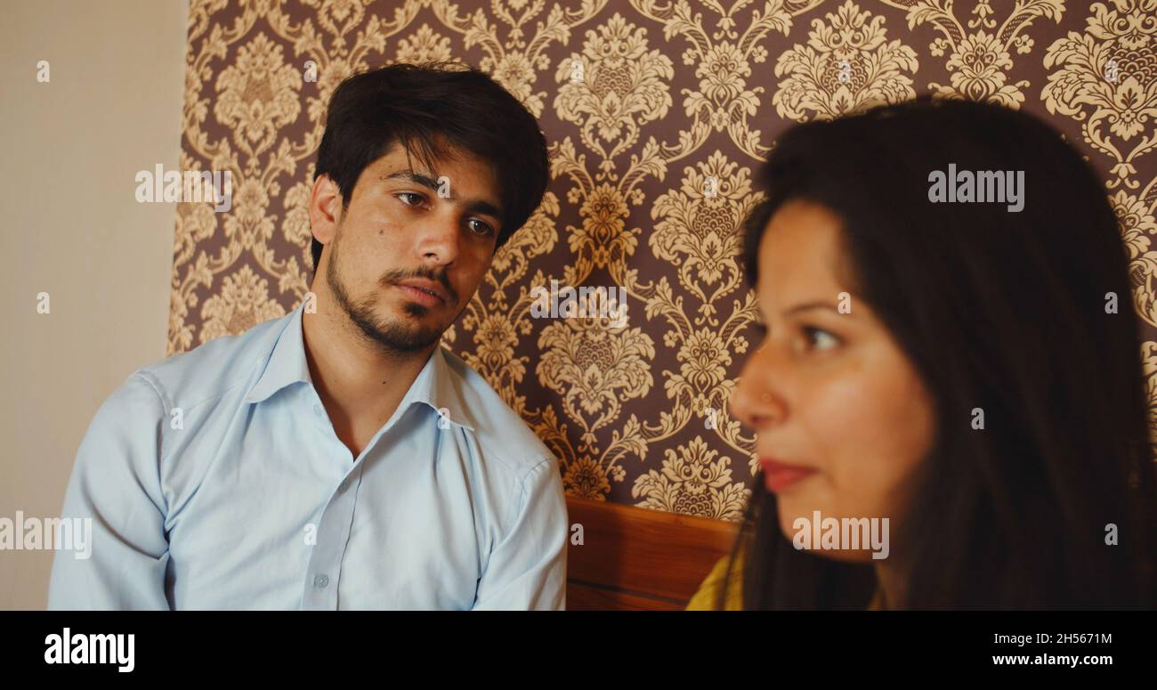 An Indian couple sitting and speaking at home Stock Photo - Alamy