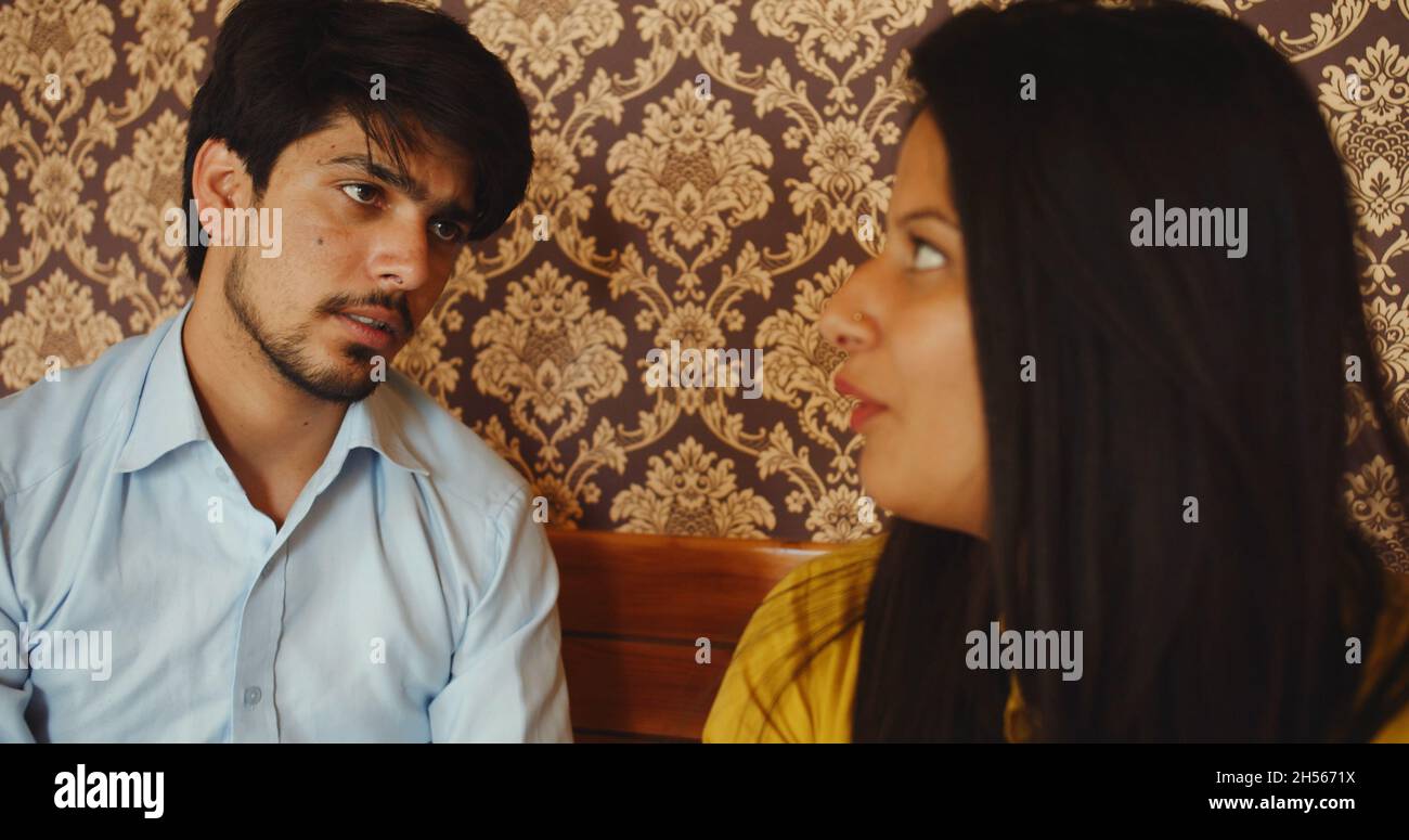 An Indian couple sitting and speaking at home Stock Photo - Alamy