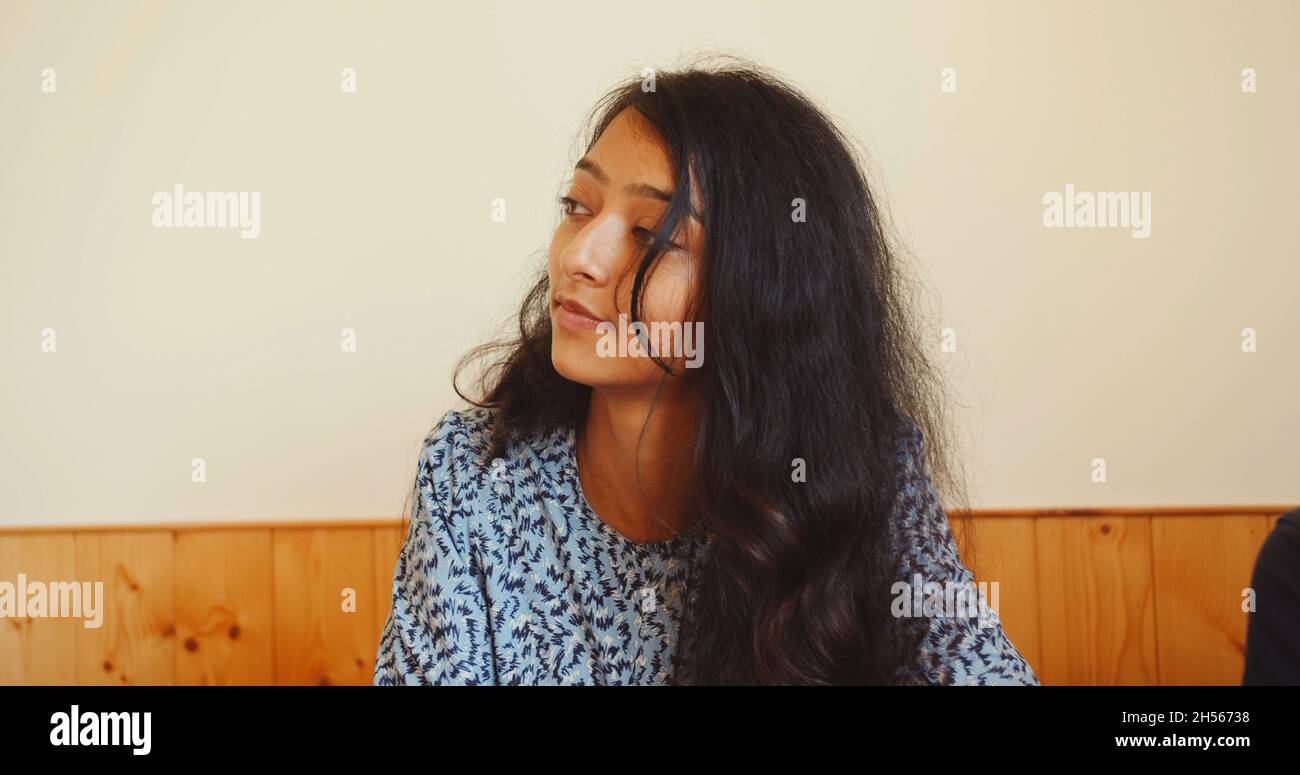An Indian woman sitting and speaking at home Stock Photo - Alamy