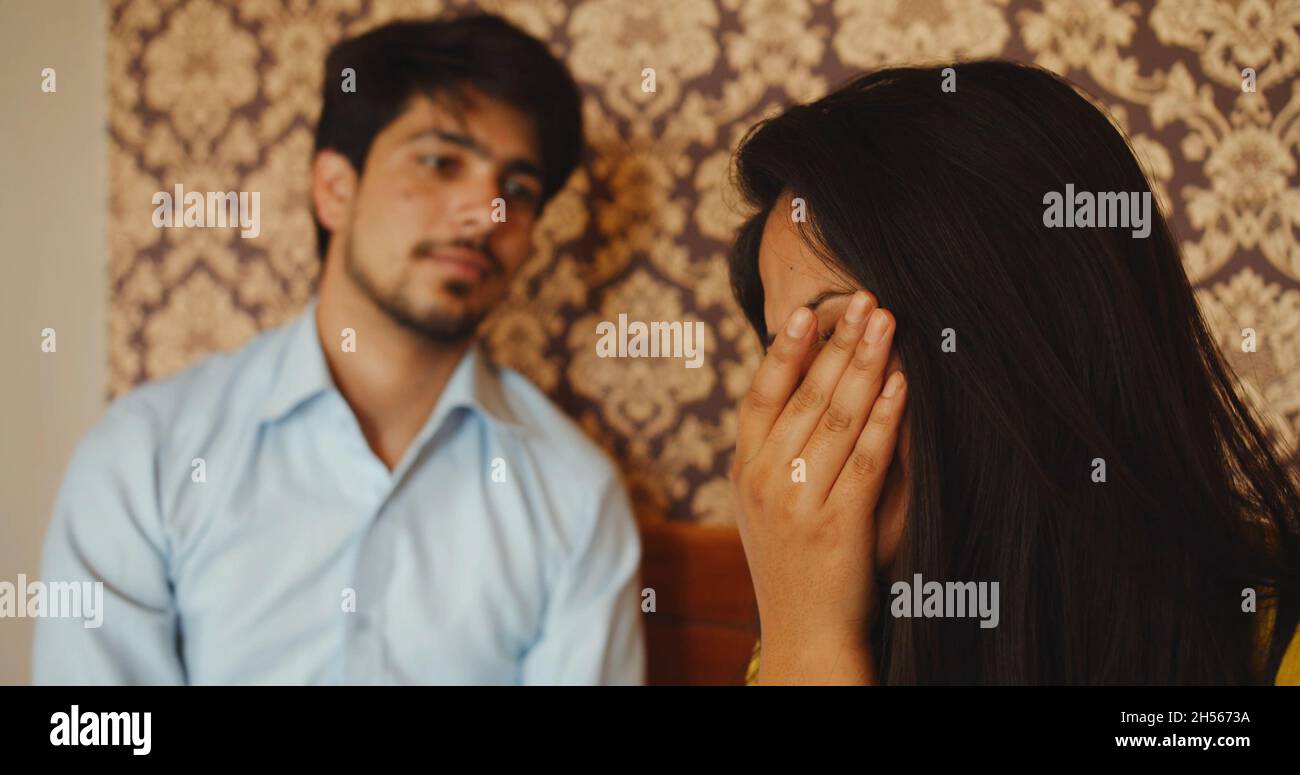 An Indian couple sitting and speaking at home Stock Photo - Alamy