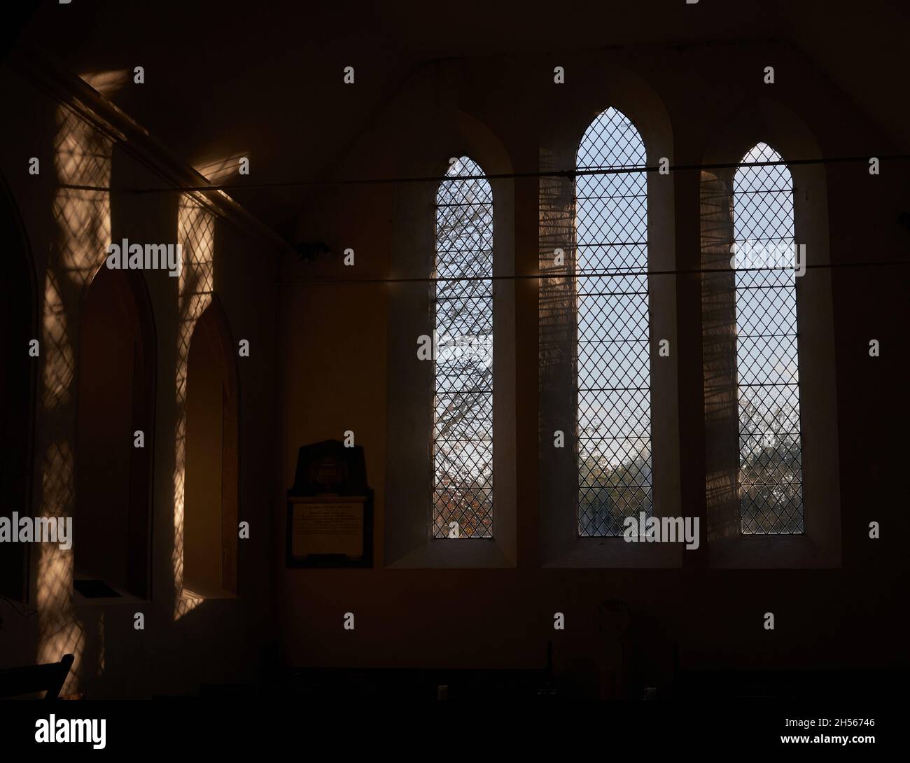Interior of church with light falling through glass lead window Stock ...