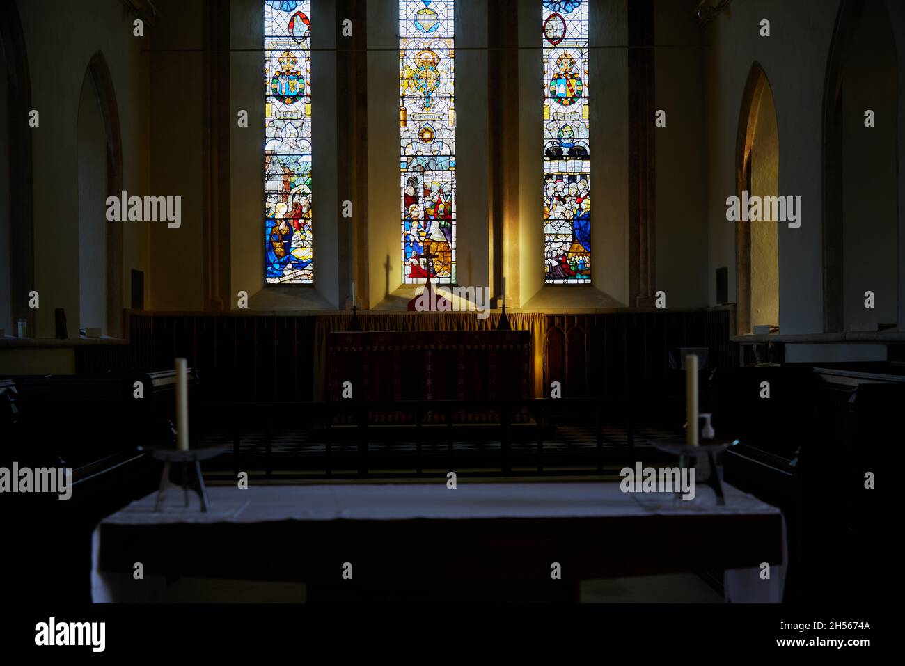 Interior of Catholic church with view of the altar and light falling ...