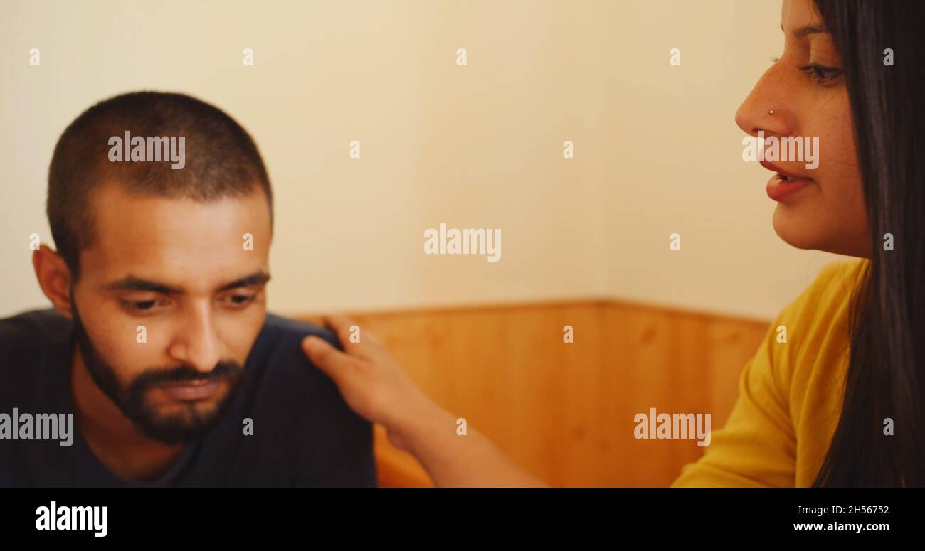 An Indian couple sitting and speaking at home Stock Photo - Alamy