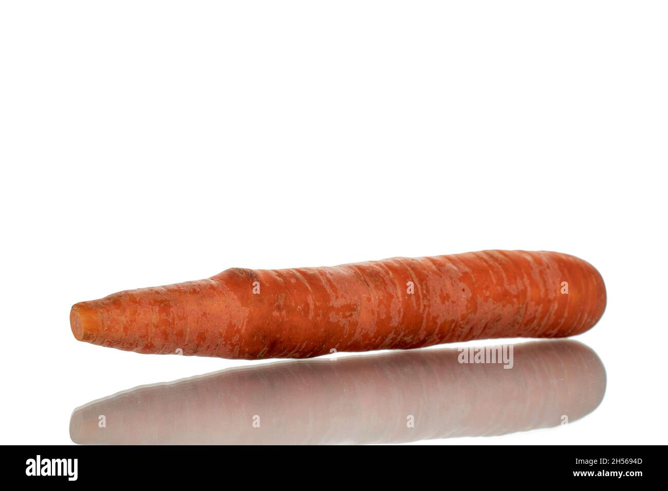 One unpeeled organic carrot, close-up, isolated on white Stock Photo ...