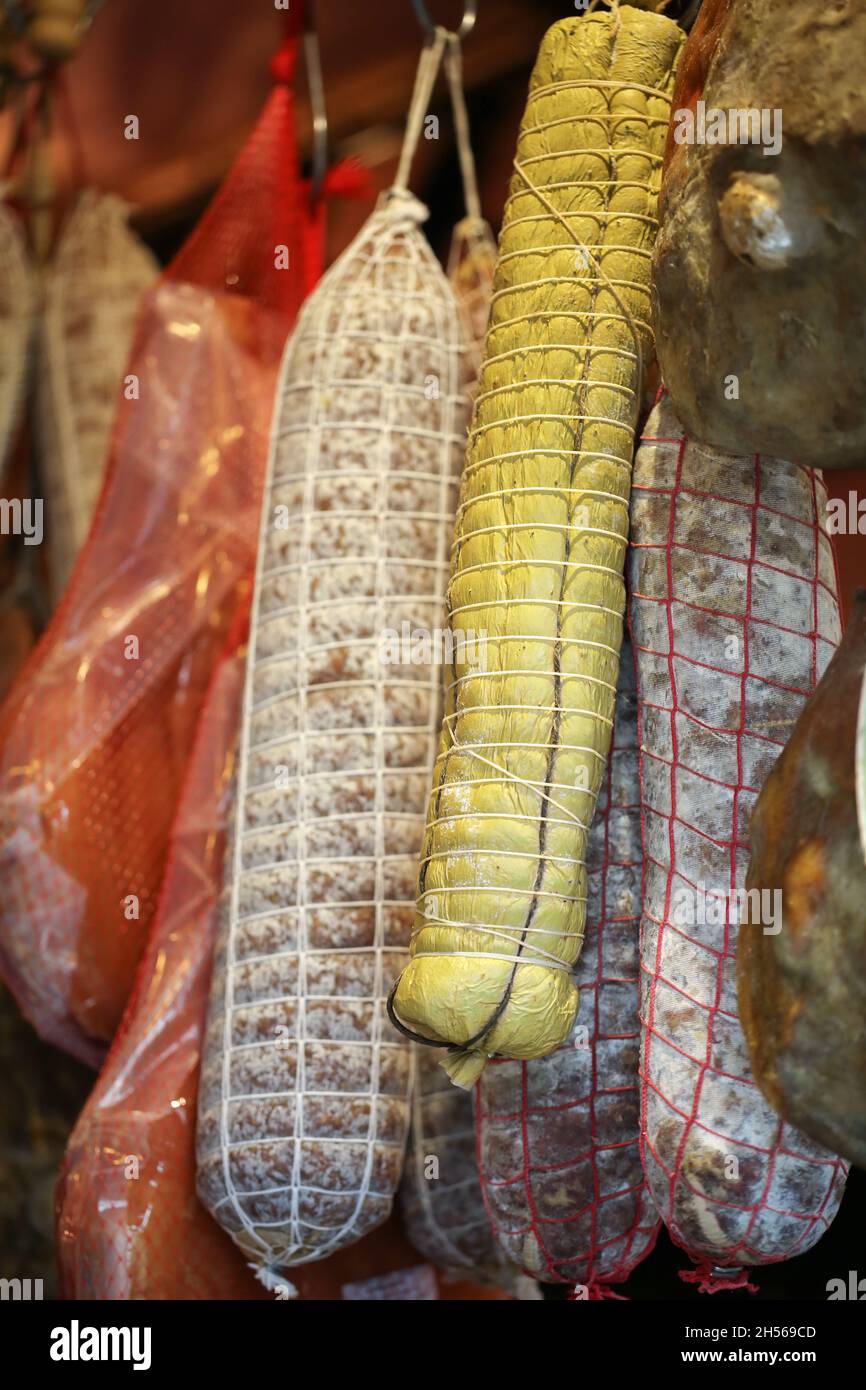 Different variety of italian salami hanging on a delicatessen shop ...