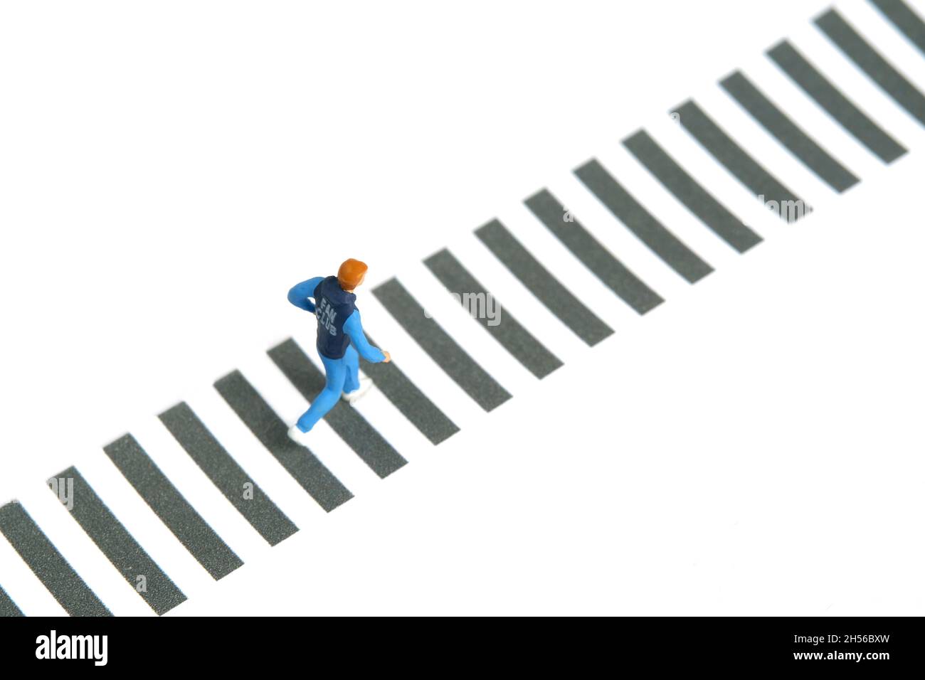 Miniature people toy figure photography. A young men running on ...