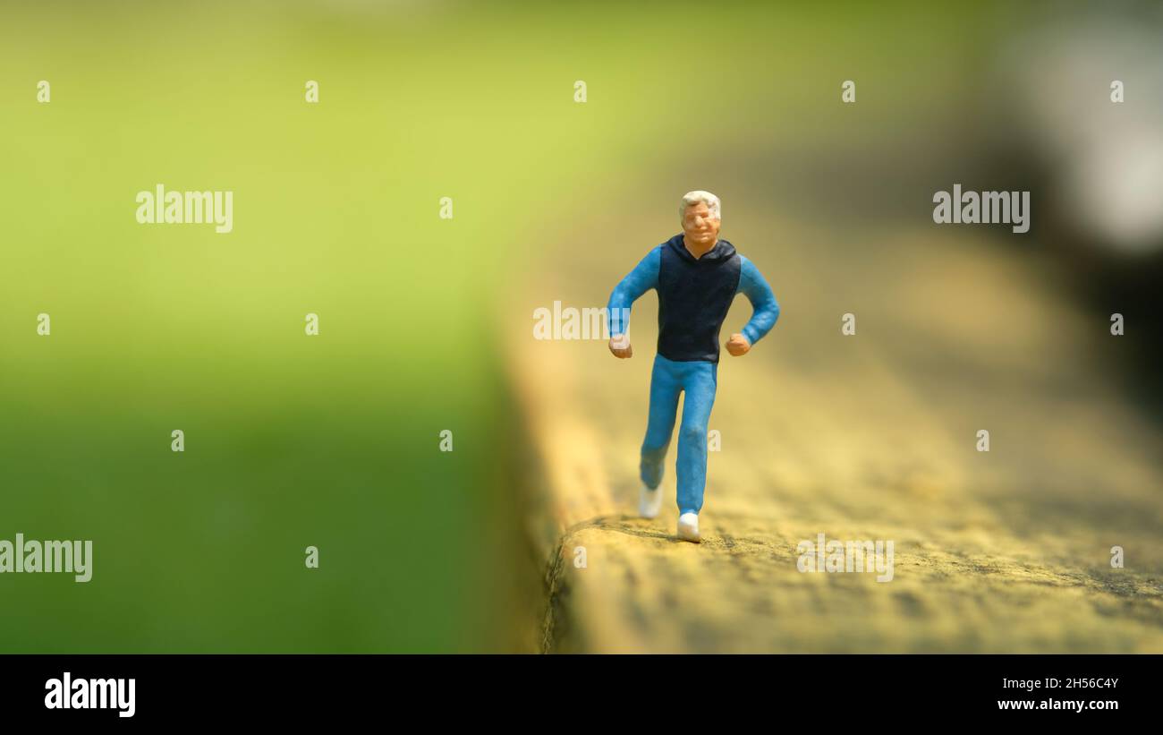 Miniature people toy figure photography. Solo jogging. A young men ...