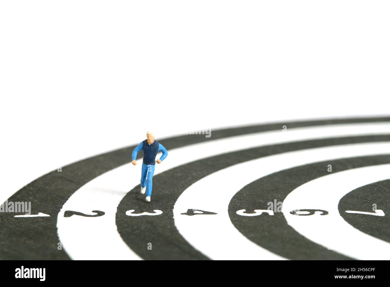 Miniature people toy figure photography. Jogging on a track concept. A ...