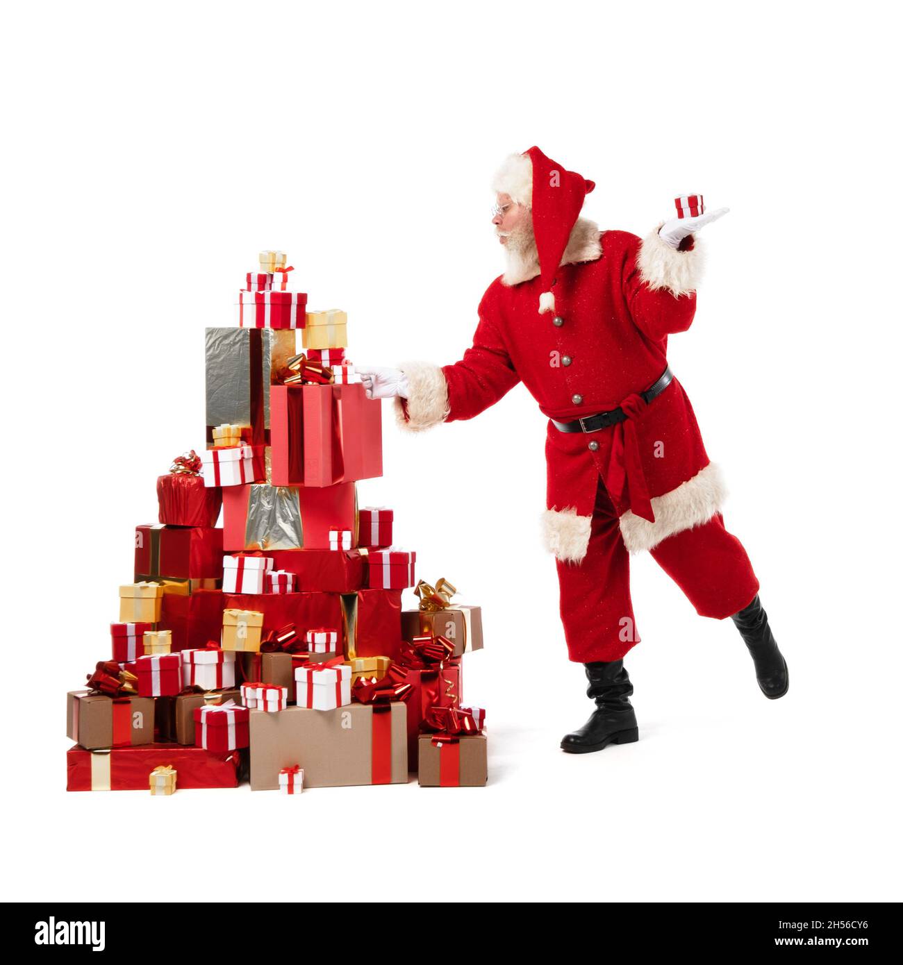 Santa Claus putting boxes into large pile of Christmas gifts isolated ...