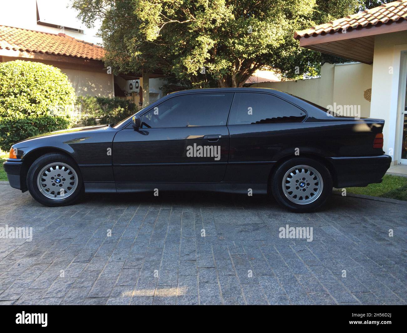 BMW 325i coupe, black color, side view, E36, parked alone. Third ...