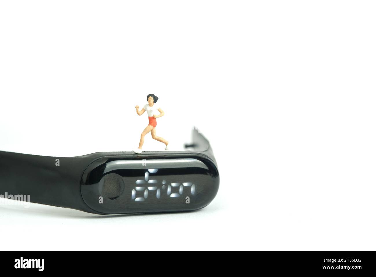 Miniature people toy figure photography. Run jogging monitoring app. A ...