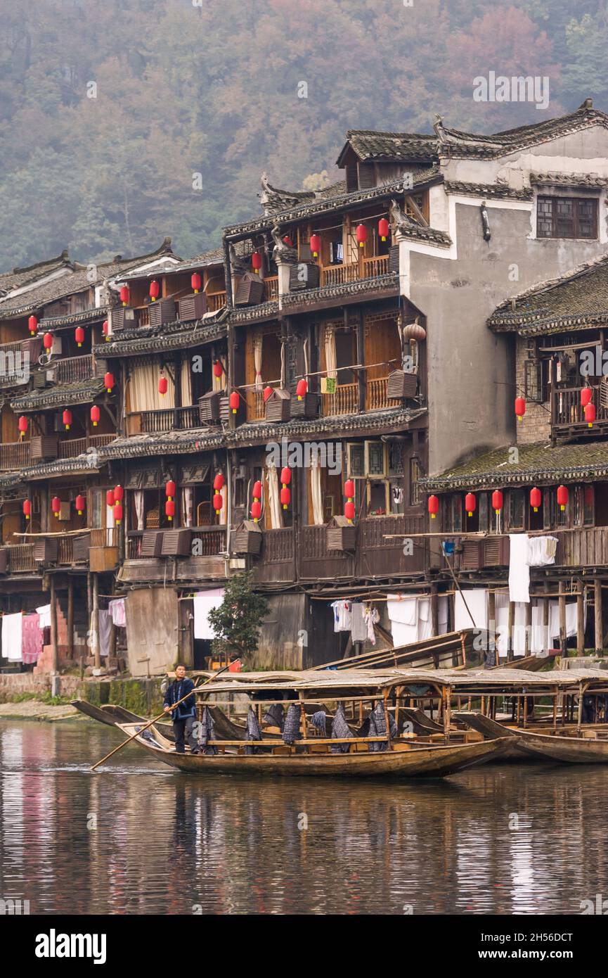 Hunan, China, 14 Nov 2011: Man rowing wooden boat along river of ...