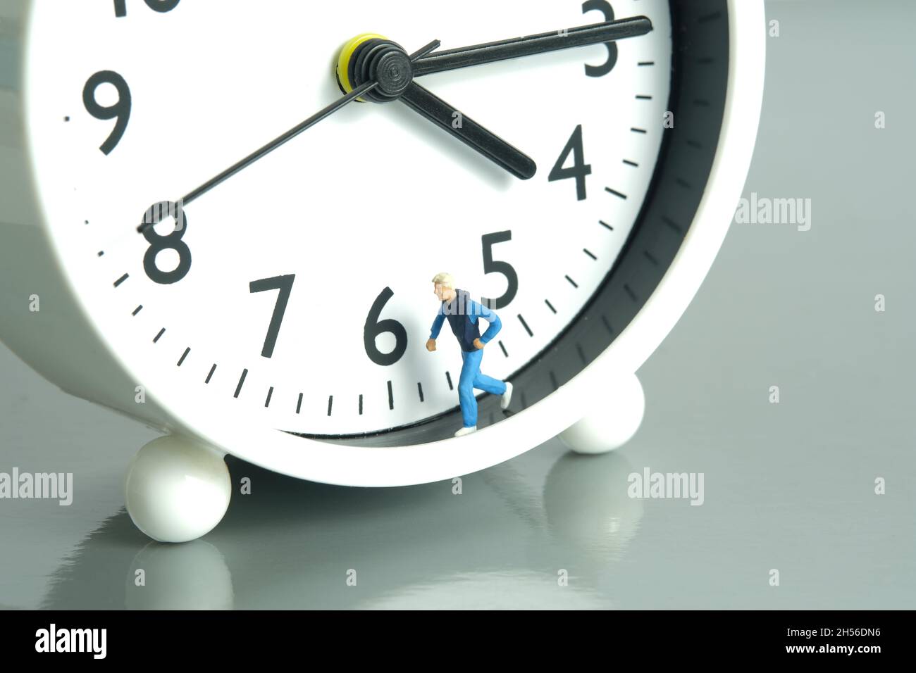 Miniature people toy figure photography. Running daily routine concept ...