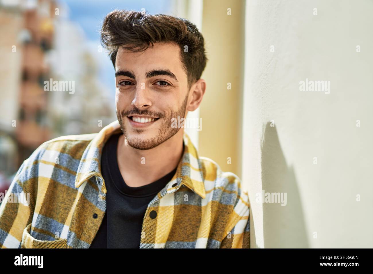 Handsome hispanic man smiling happy and confident at the city Stock ...