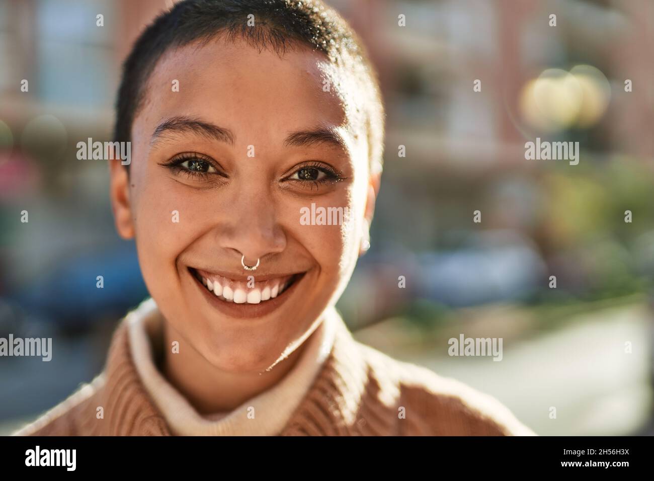 Beautiful hispanic woman with short hair smiling happy outdoors Stock ...