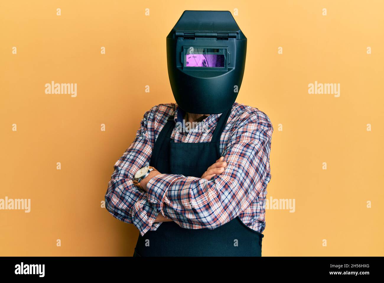 Repair man wearing professional welding mask over head covering face ...