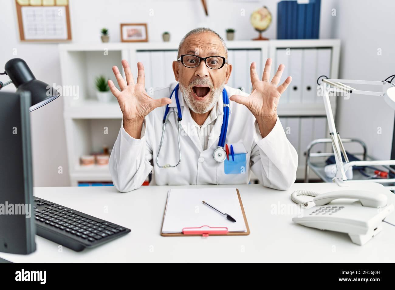 Mature doctor man at the clinic celebrating crazy and amazed for ...