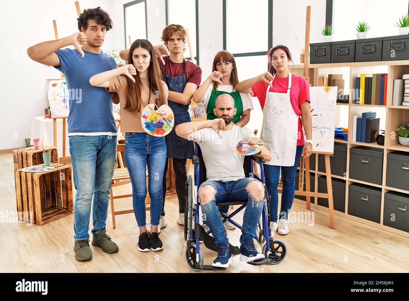 Group of young artists people at art studio with angry face, negative ...
