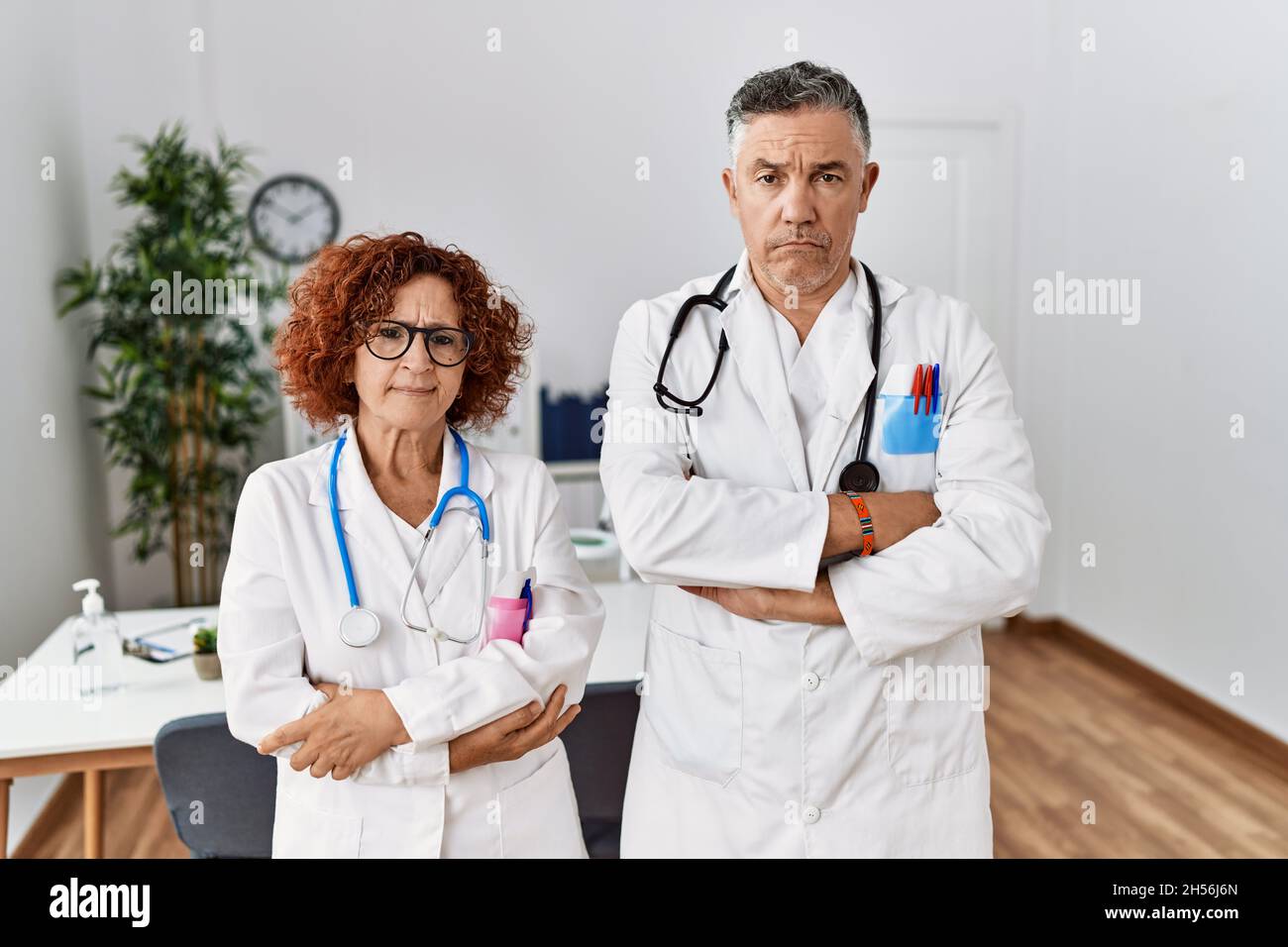 Two middle age doctors at medical clinic skeptic and nervous ...