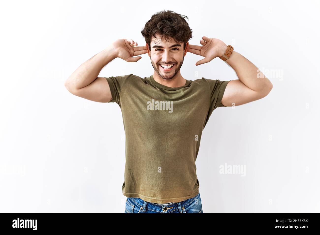 Hispanic man standing over isolated white background smiling pulling ...