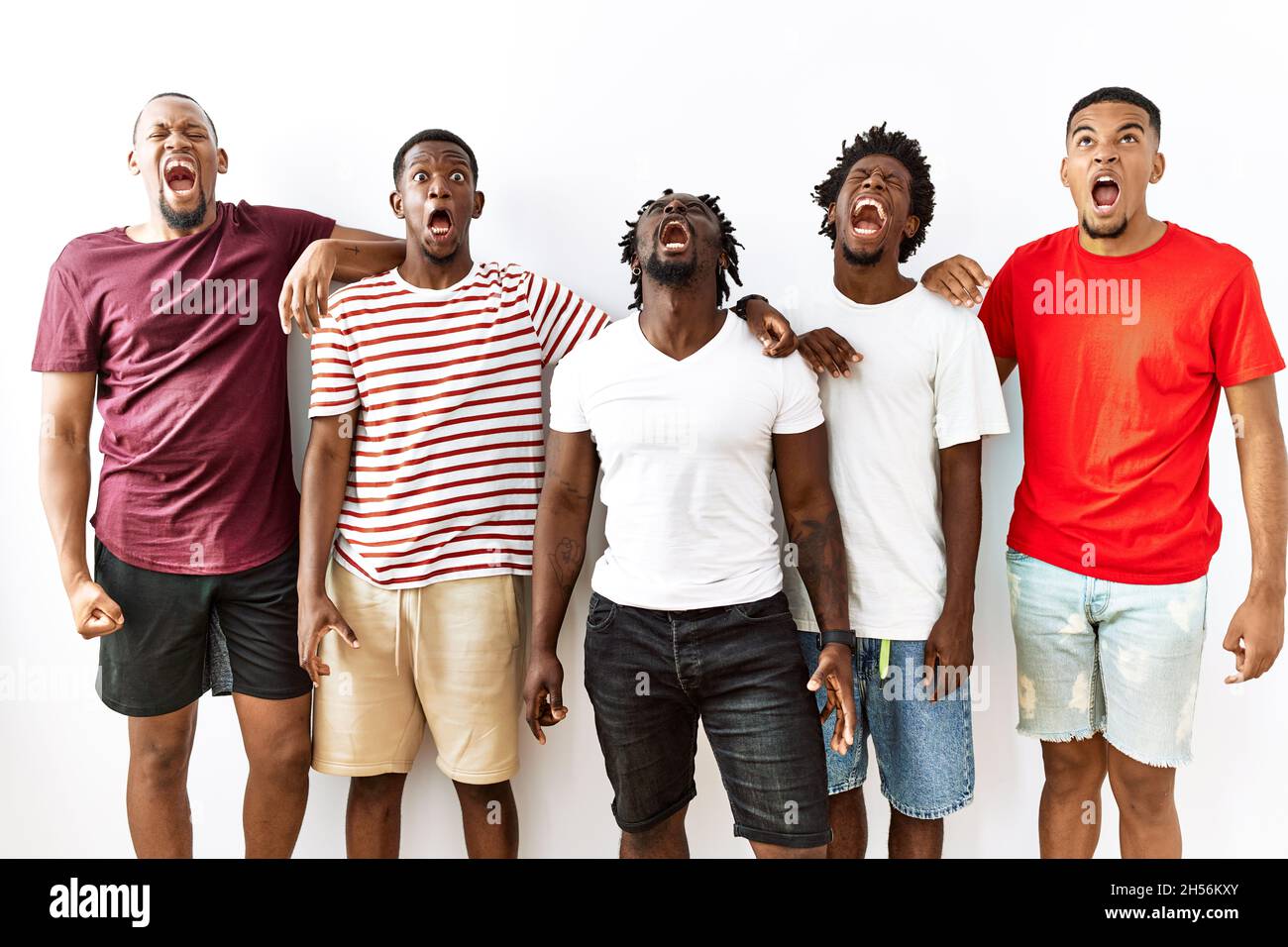 Young african group of friends standing together over isolated ...