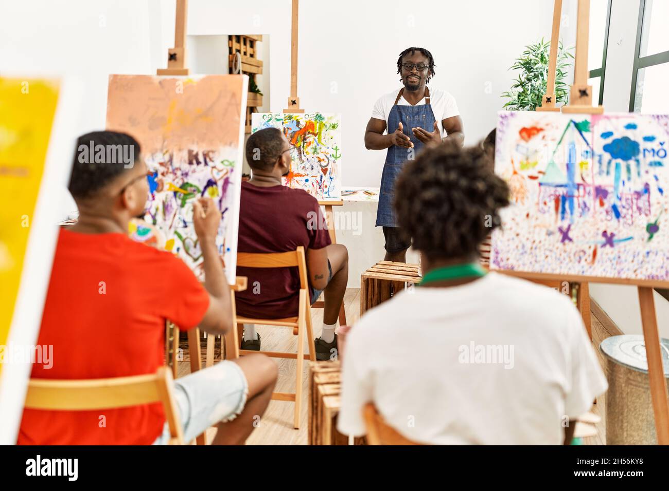 Group of young african american artist students drawing in paint class ...