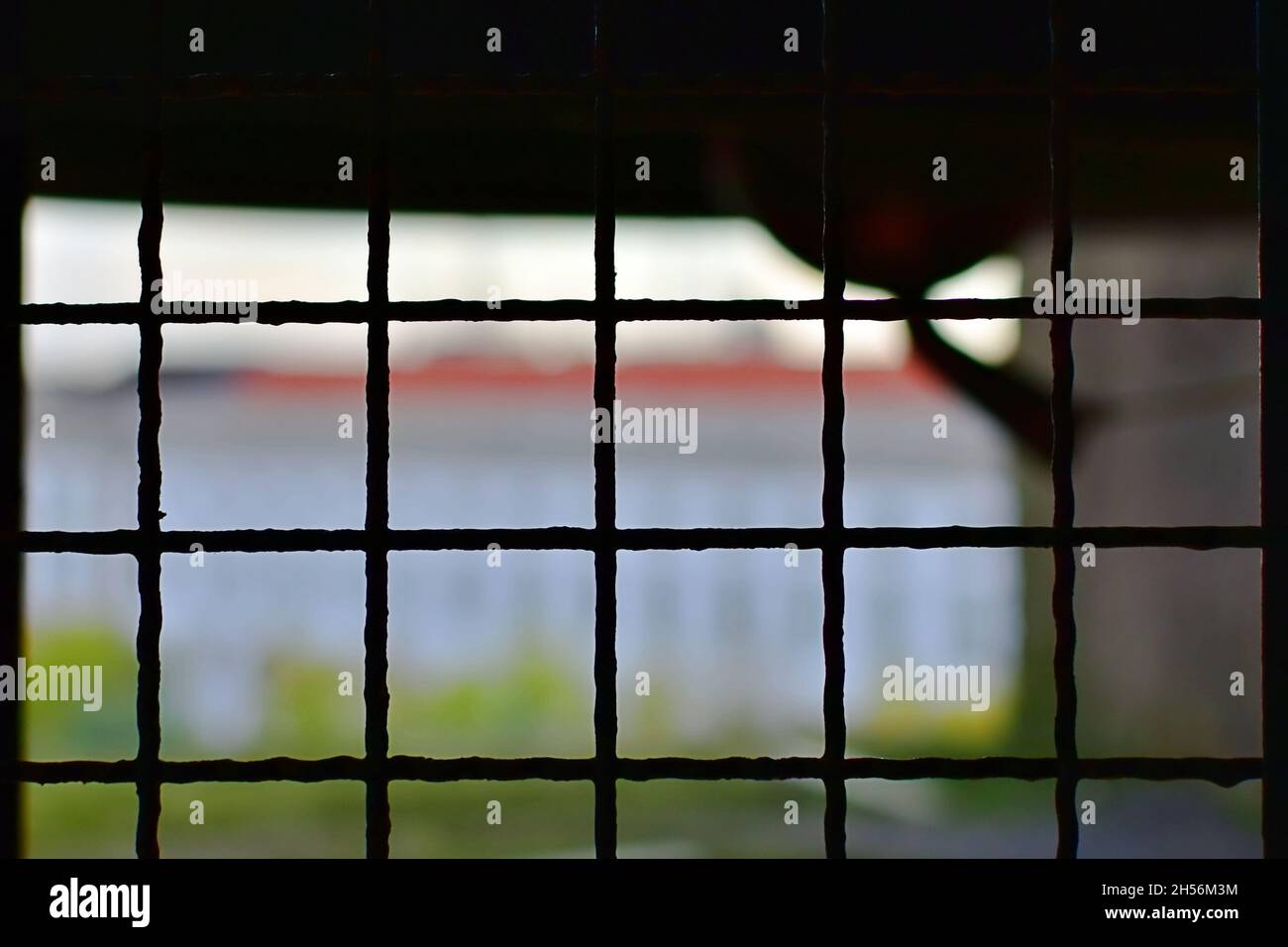 Metal grate in window opening on blurred colored background Stock Photo ...