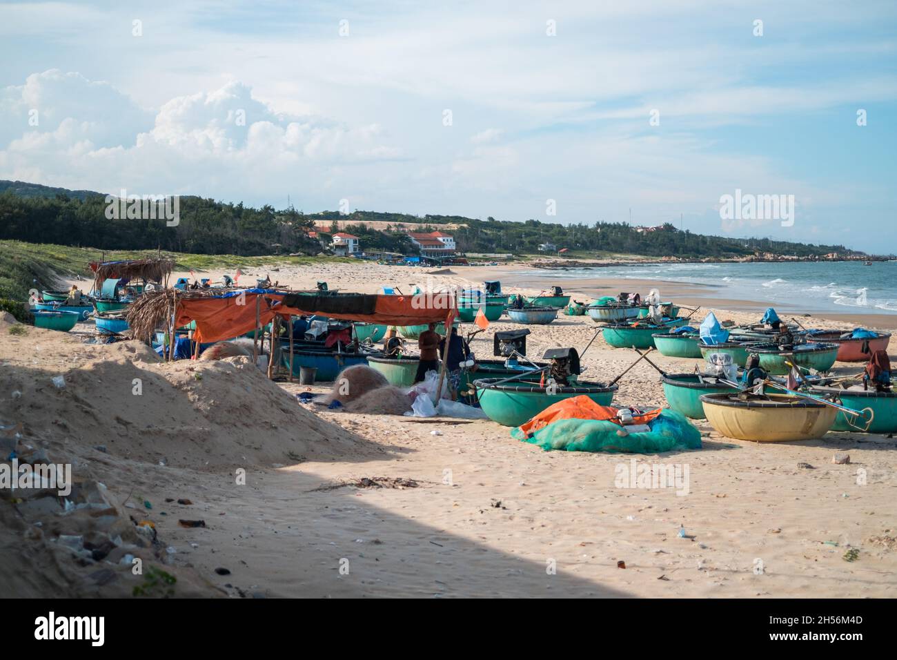 Scenic view of the beach with colourful fishing boats and poor fishing ...
