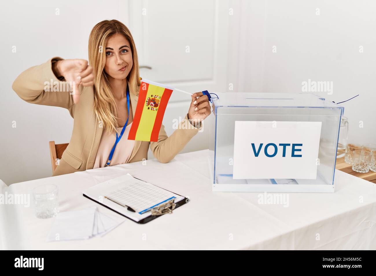 Blonde beautiful young woman at political campaign election holding ...