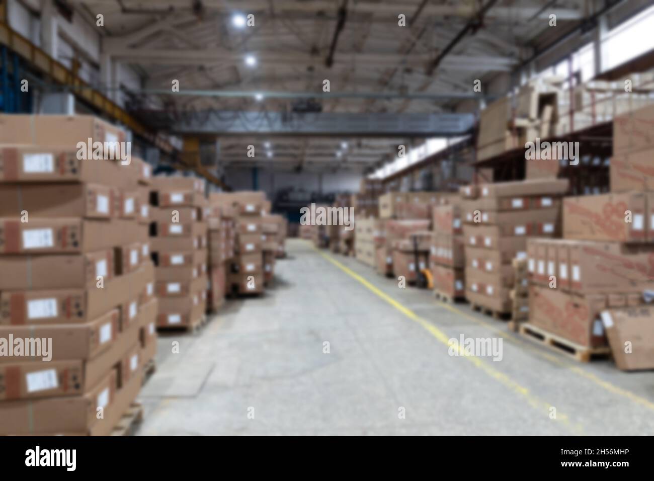 finished goods warehouse, large room with cardboard boxes, blurred ...