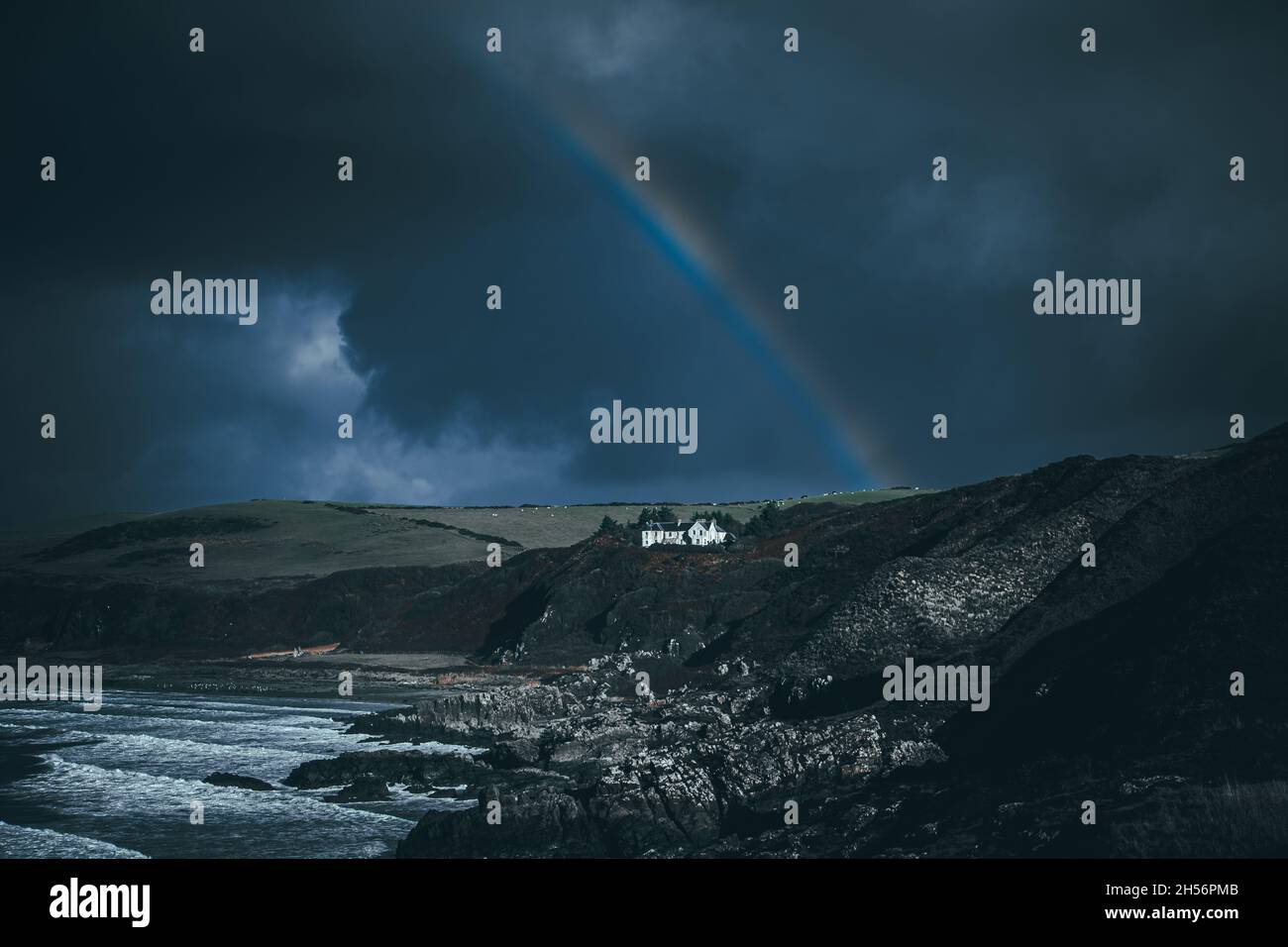 A rainbow emerges after a storm on the Dumfries & Galloway coast Stock ...