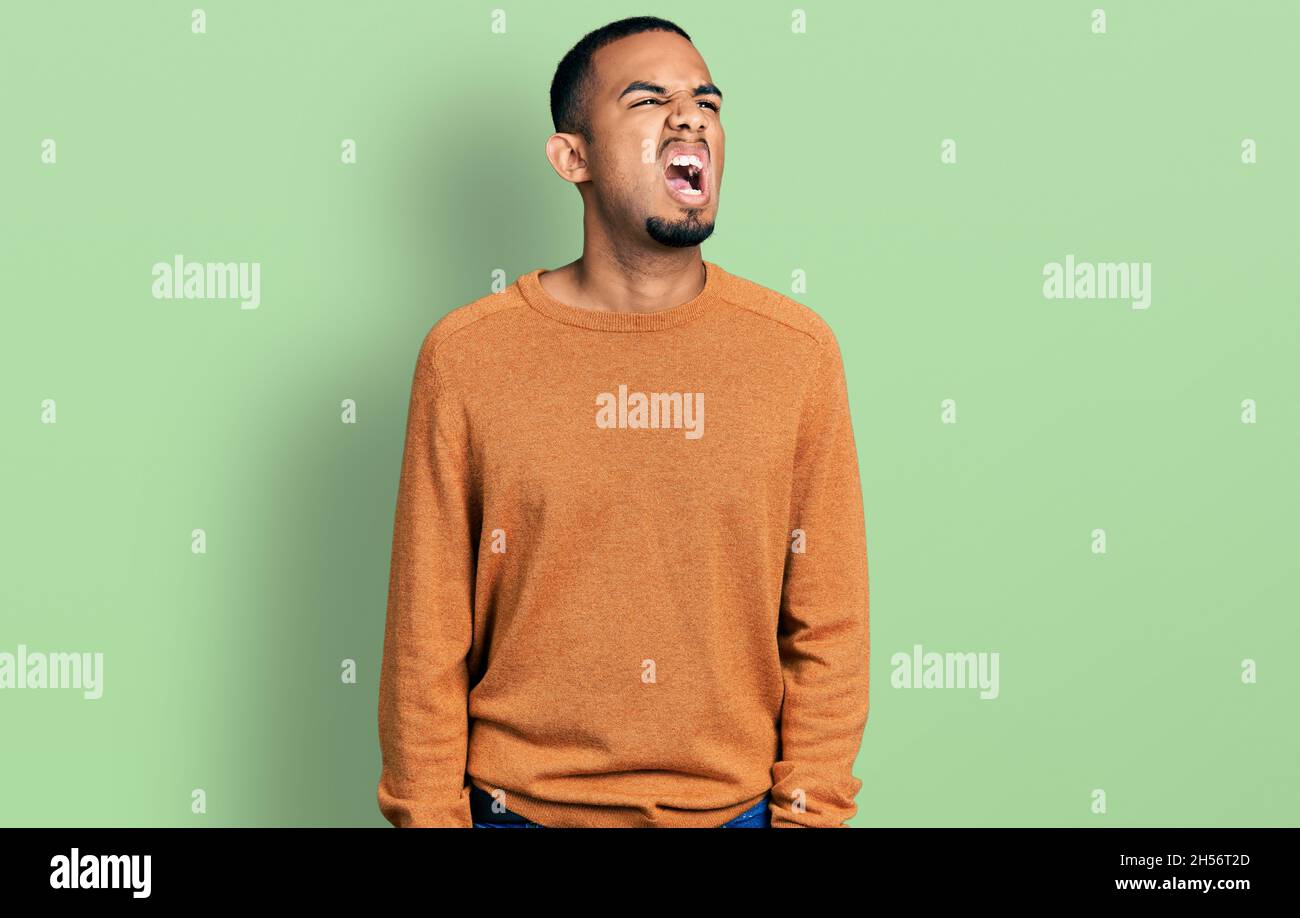 Young african american man wearing casual clothes angry and mad ...