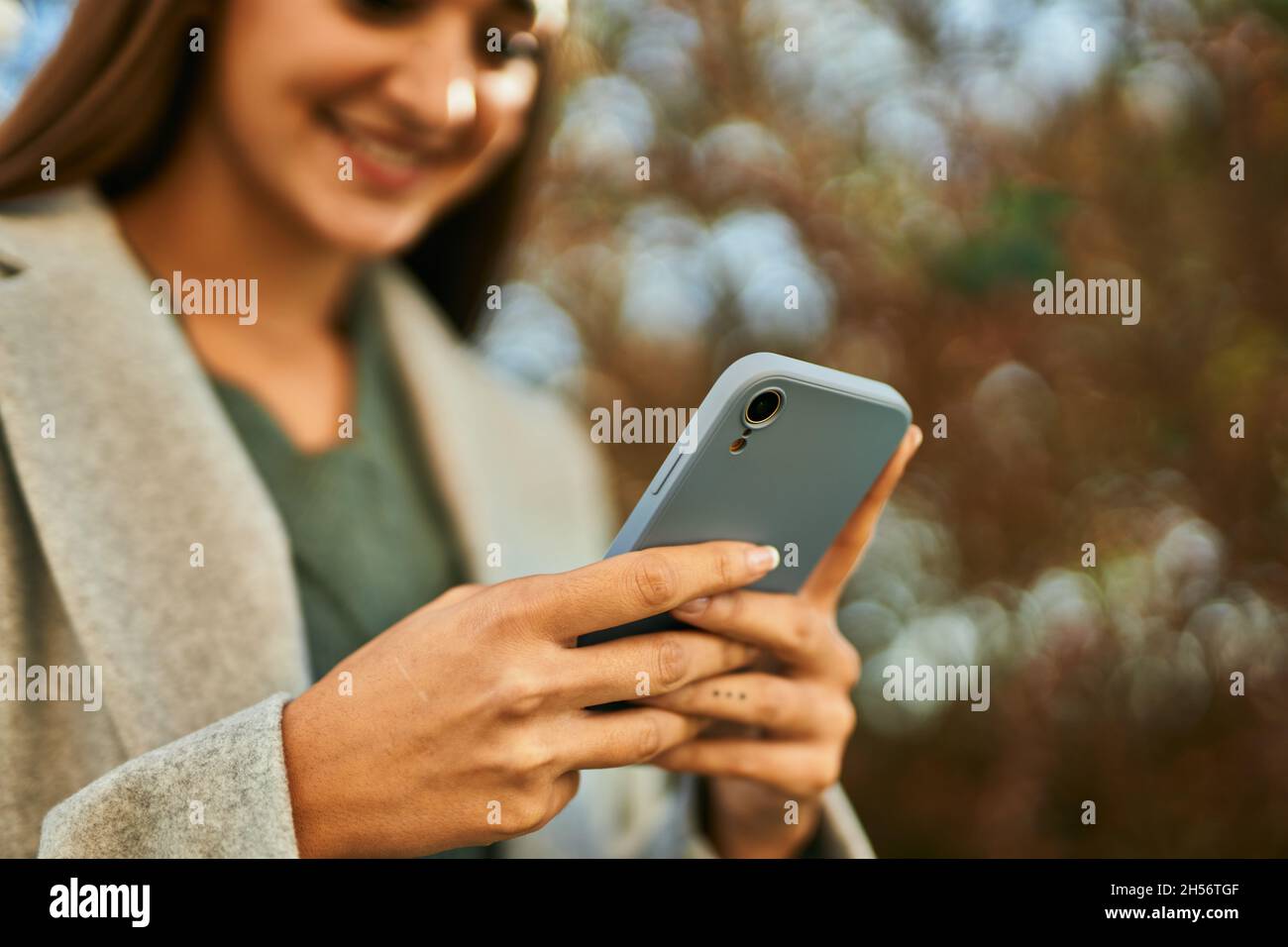 Young hispanic girl smiling happy using smartphone at the city Stock ...