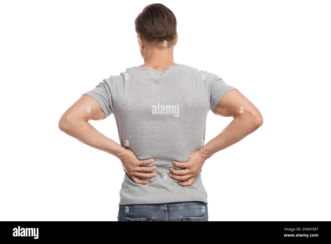 Millennial caucasian attractive guy presses his hands to sore spot and ...