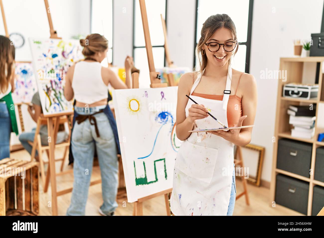 Group of young people smiling happy drawing at art studio Stock Photo ...