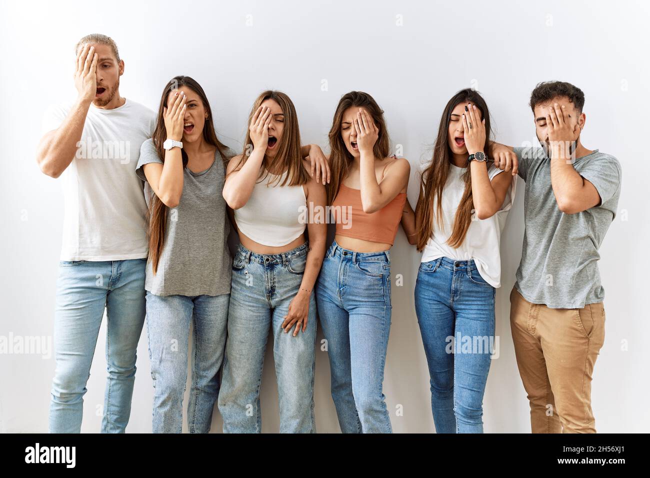 Group of young friends standing together over isolated background ...