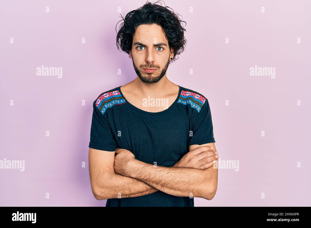Handsome hispanic man with arms crossed gesture depressed and worry for ...