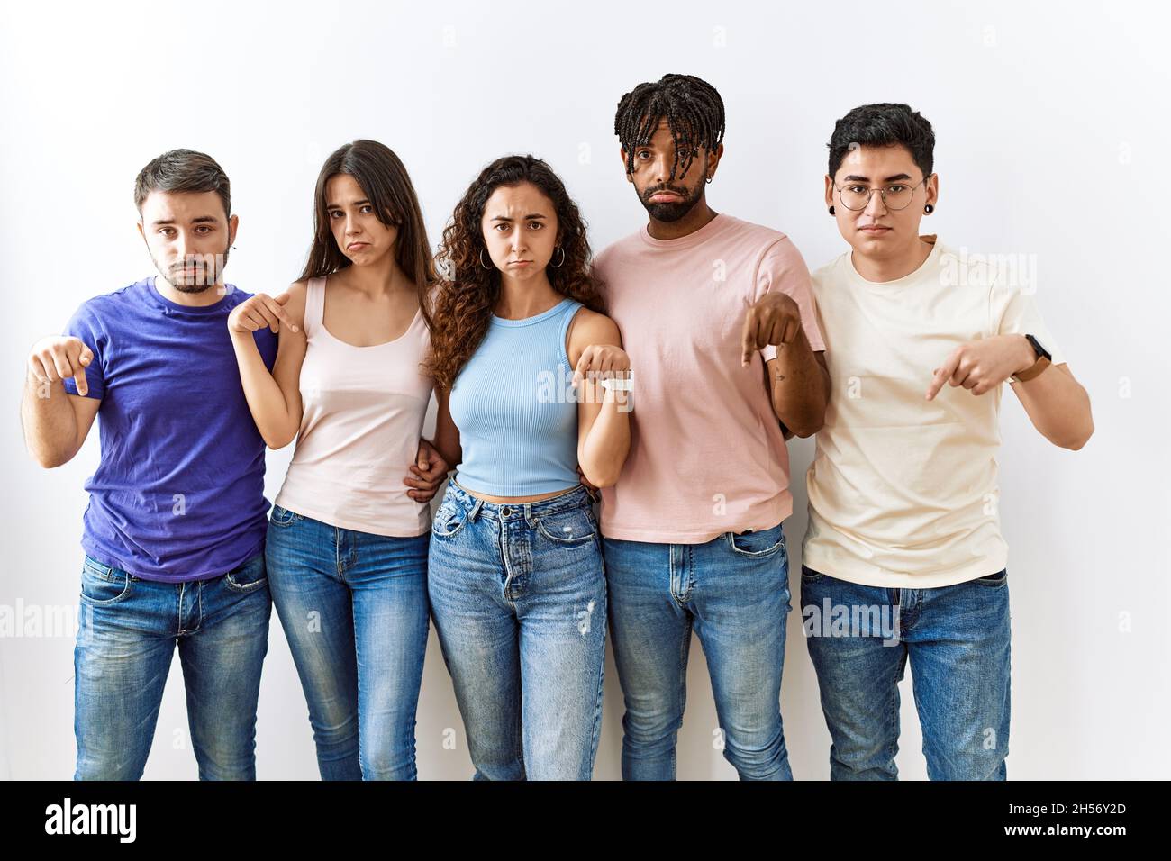 Group of young people standing together over isolated background ...