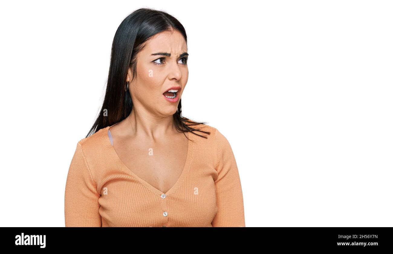 Young hispanic woman wearing casual clothes angry and mad screaming ...