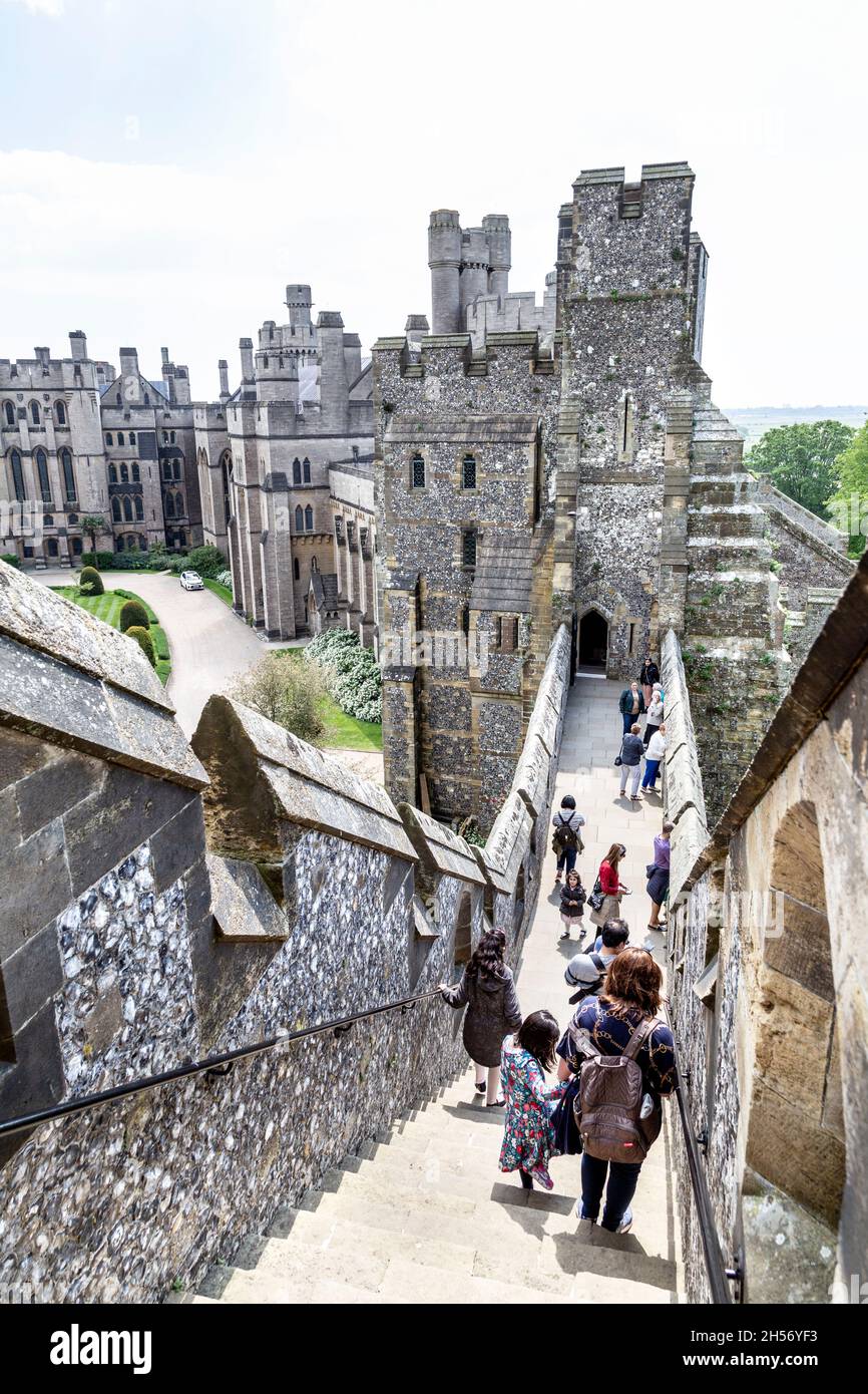Tourists walking down the stairs leading down from the Keep at Arundel ...
