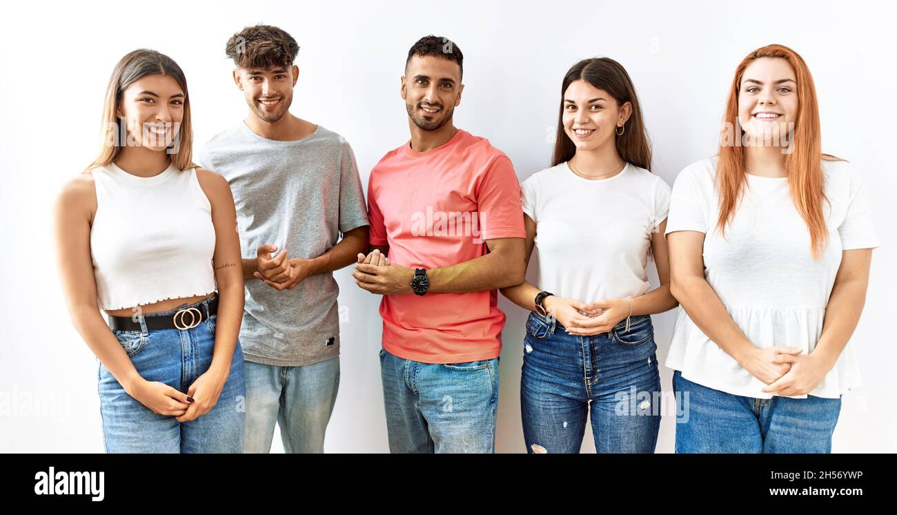 Group of young friends standing together over isolated background with ...