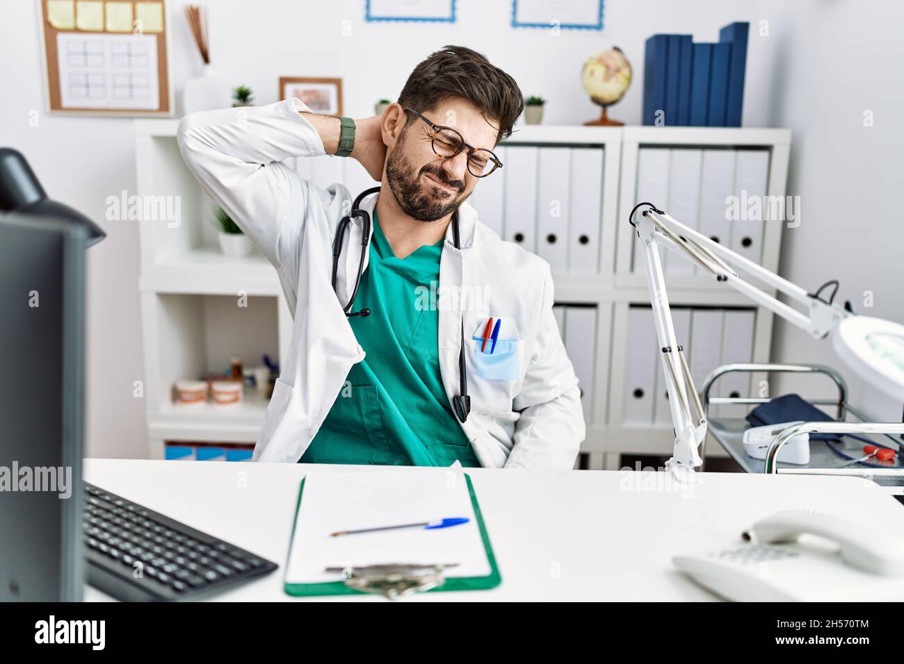 Young man with beard wearing doctor uniform and stethoscope at the ...