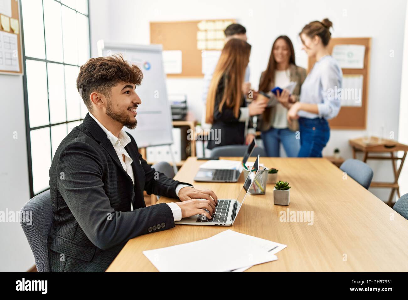 Young business worker smiling happy working while partners have break ...