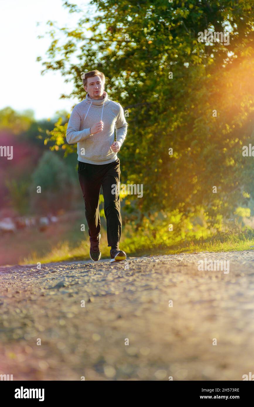Running man jogging in rural nature at beautiful summer day. Sport ...