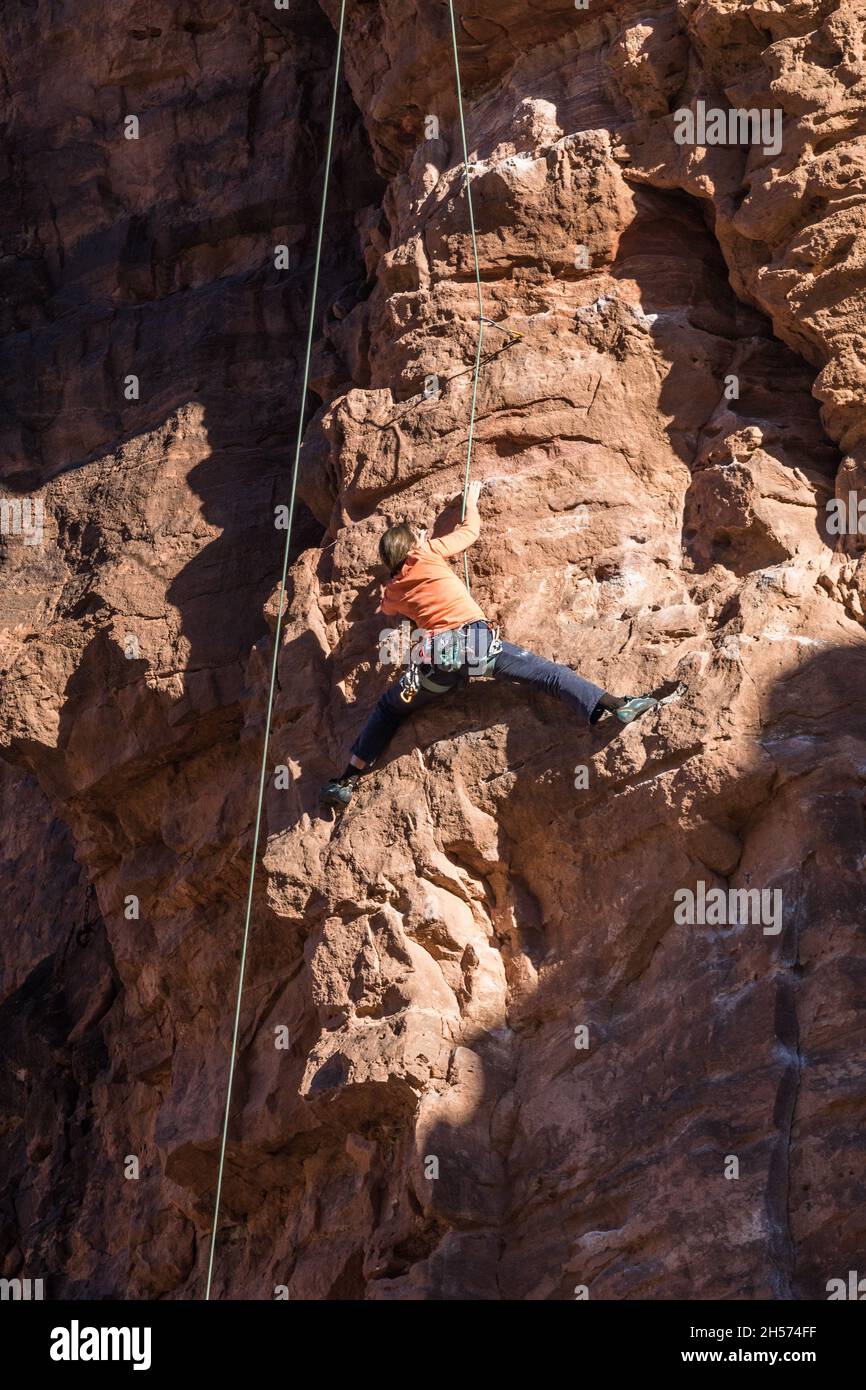 A female sport climber on top rope climbs the wall called the Theater ...