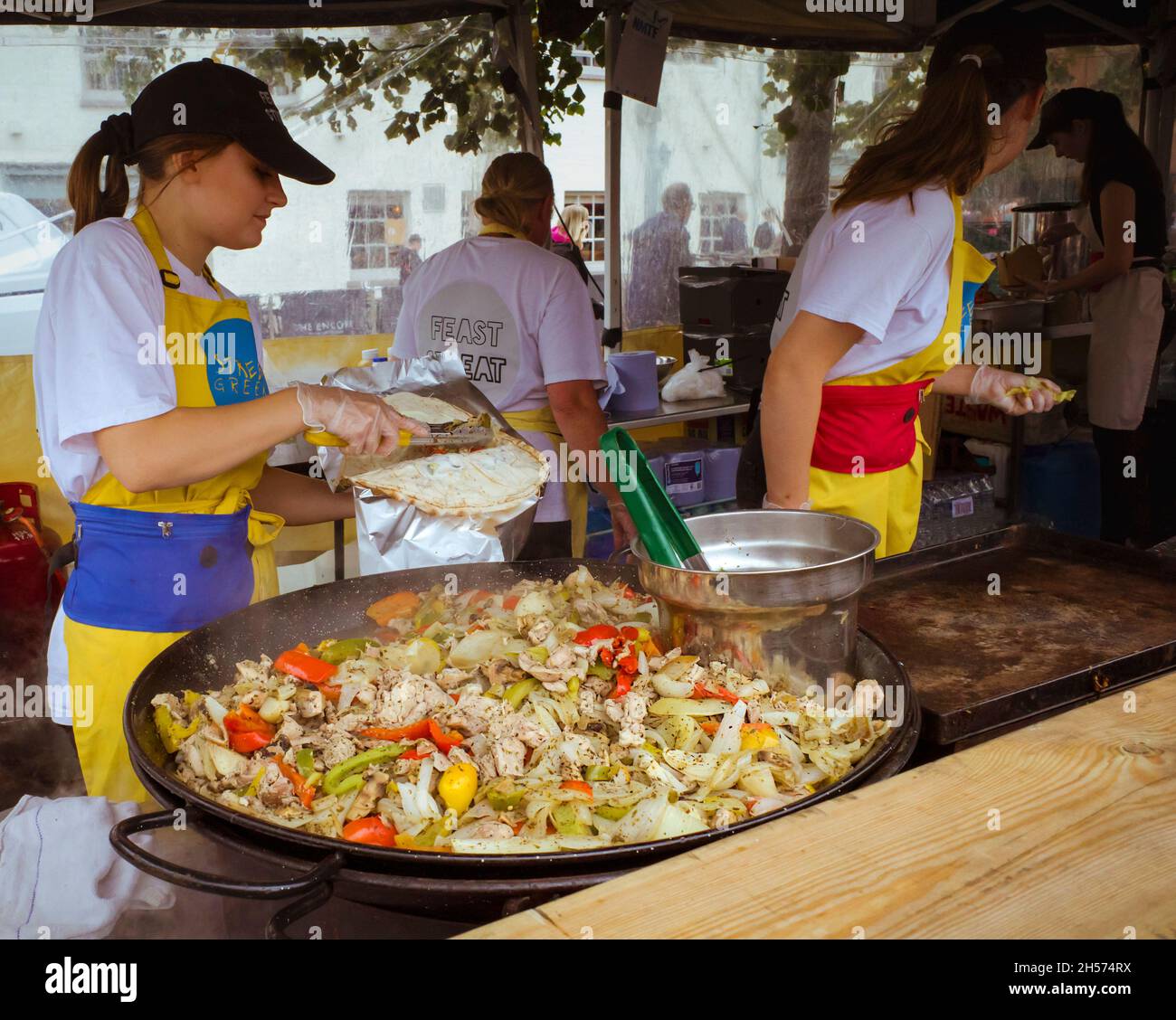 Delicious street food being prepared and served by a team of females at ...