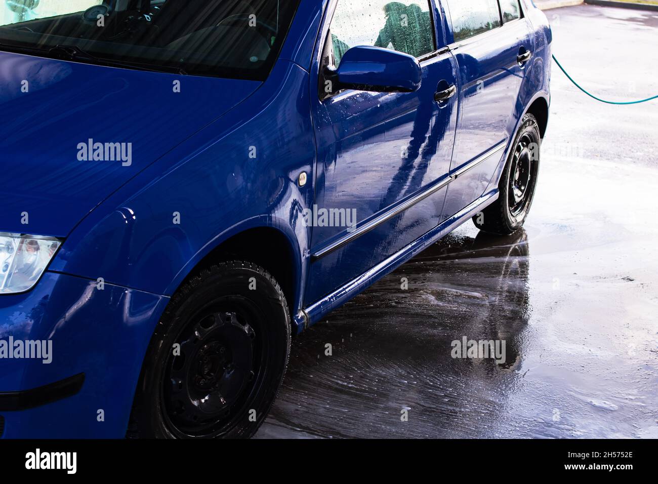 Blue car in foam at a car wash close up Stock Photo - Alamy