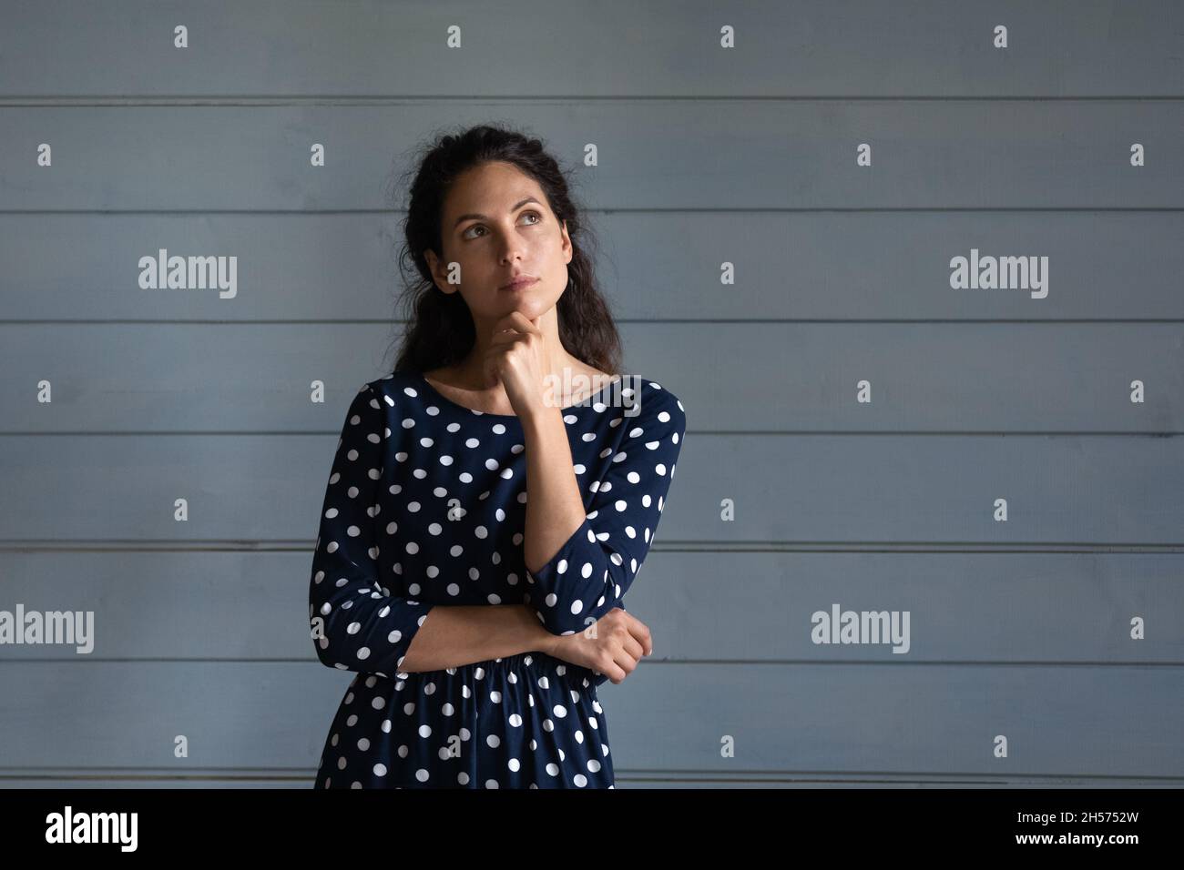 Puzzled latin millennial lady reflect on idea make choice decision ...